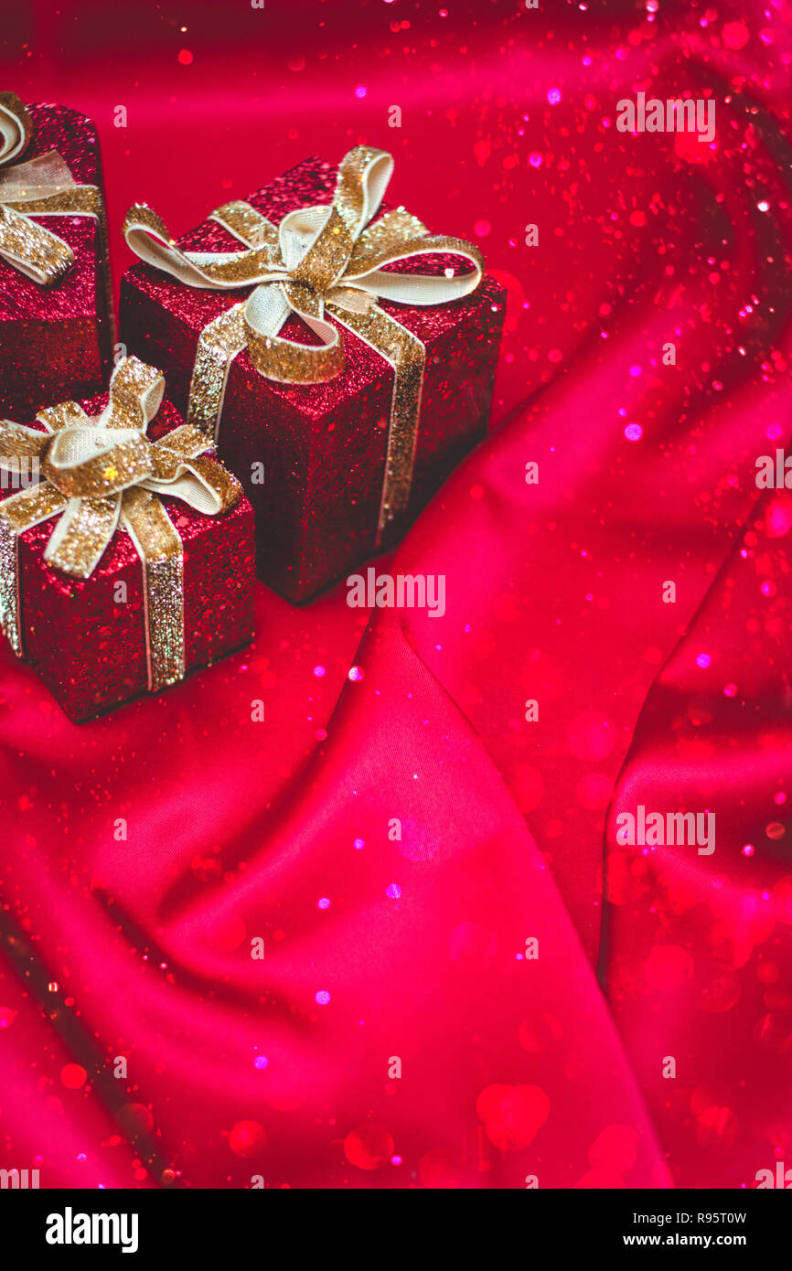 Sparkly red present boxes with Christmas lights and decorations on a ...