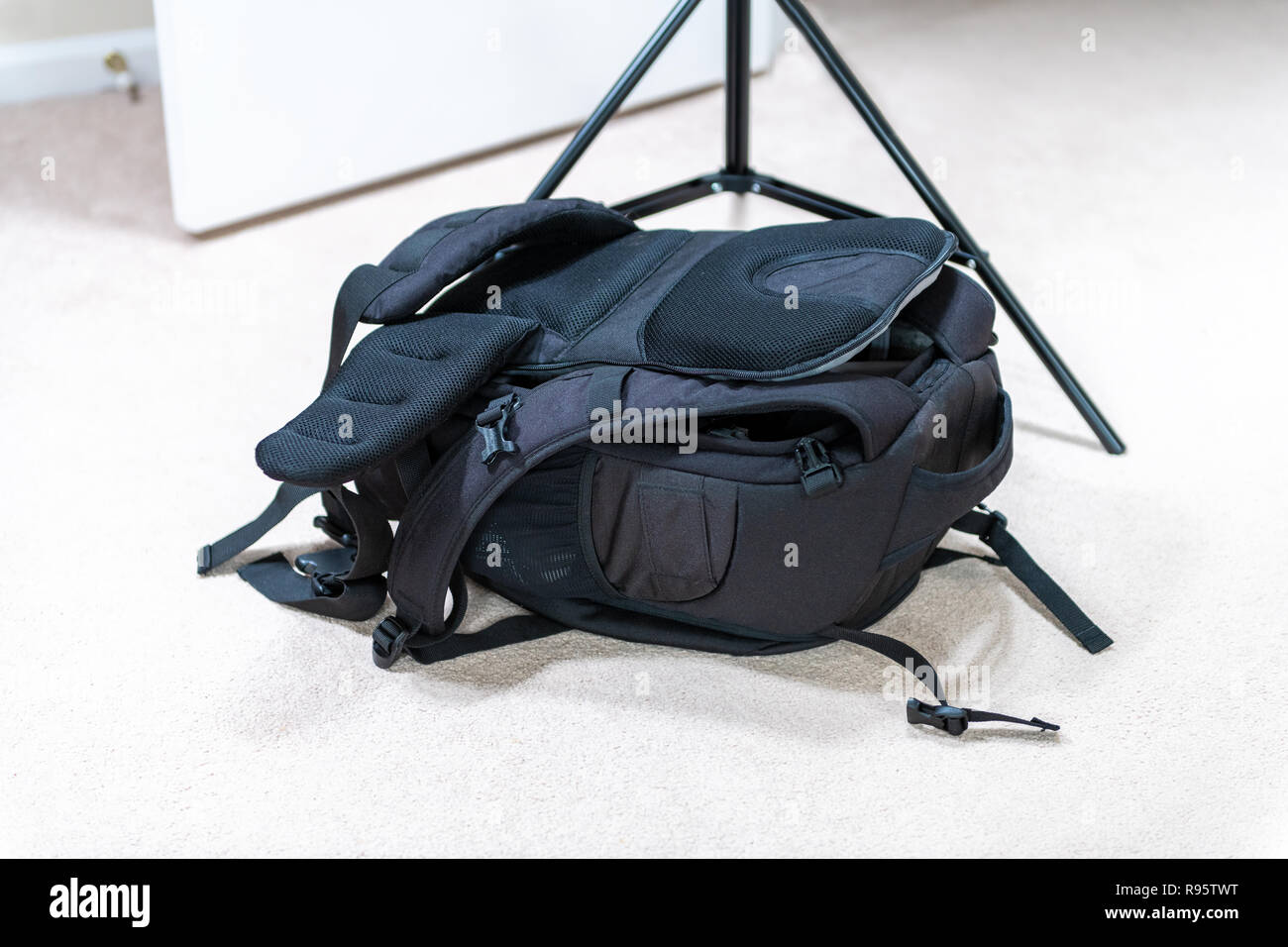 Closeup of black photography opened backpack, light stand in domestic ...