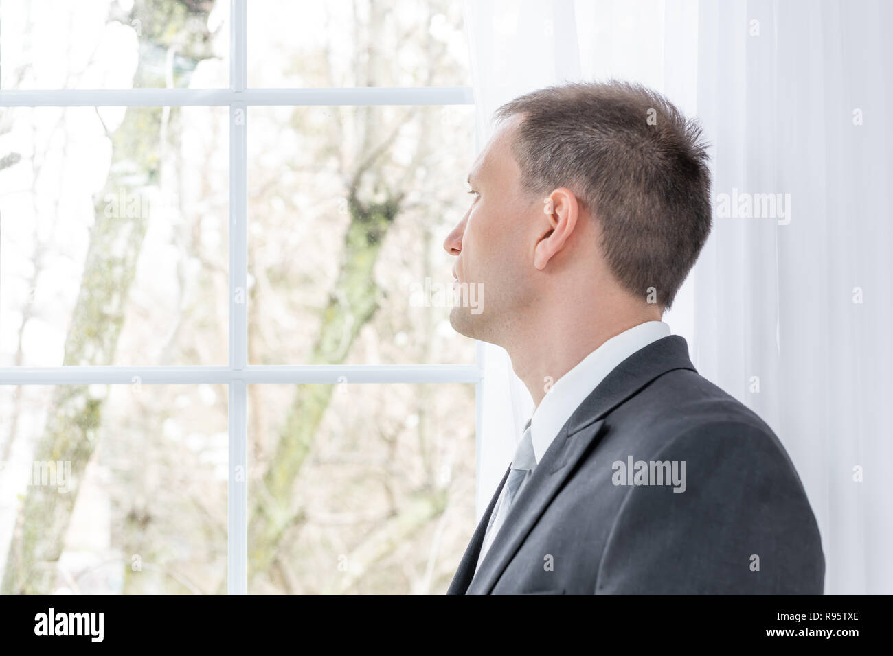 Man standing side view suit hi-res stock photography and images - Alamy