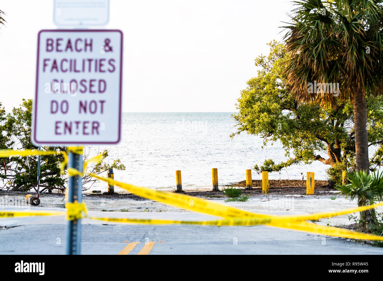 Beach, facilities closed, do not enter sign post by coast, shore after ...
