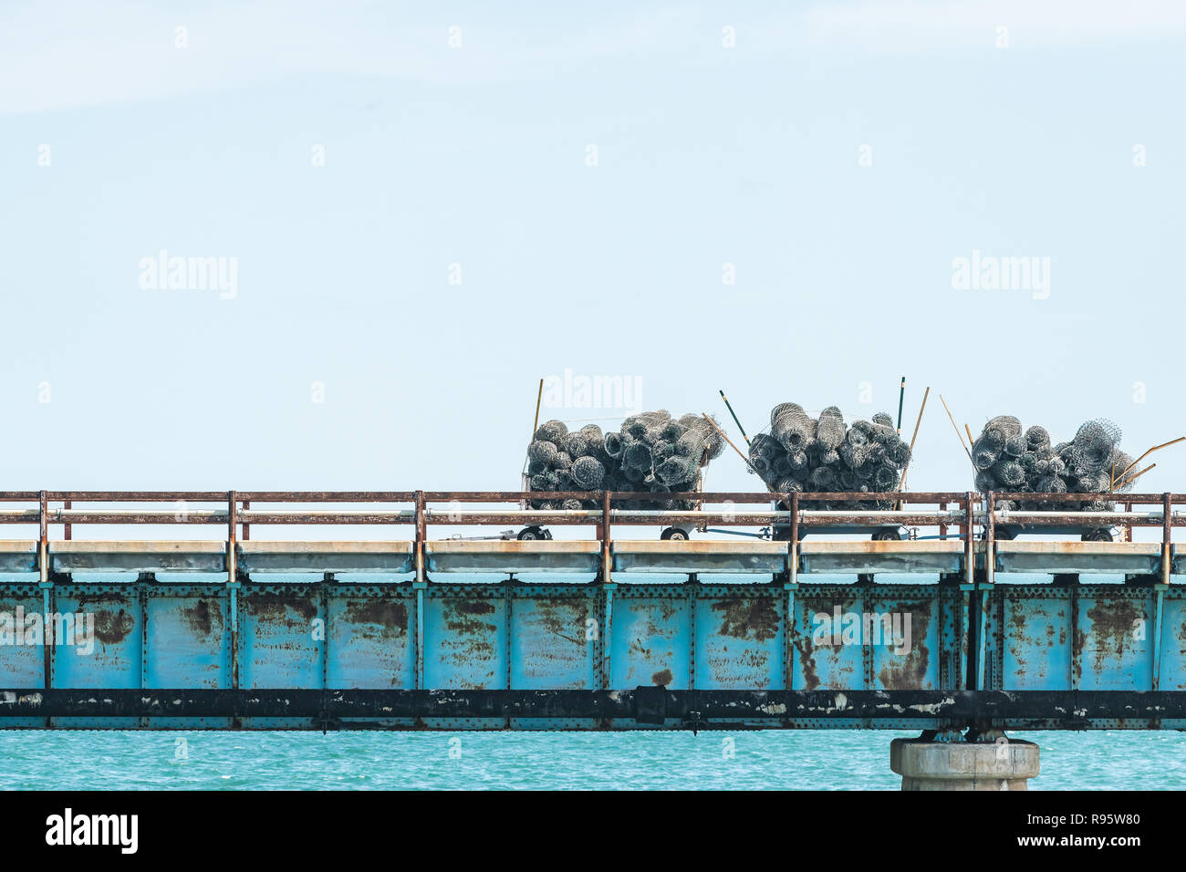 Stacks of barbed wire, wired fence metal, steel rolls on dollies on old ...