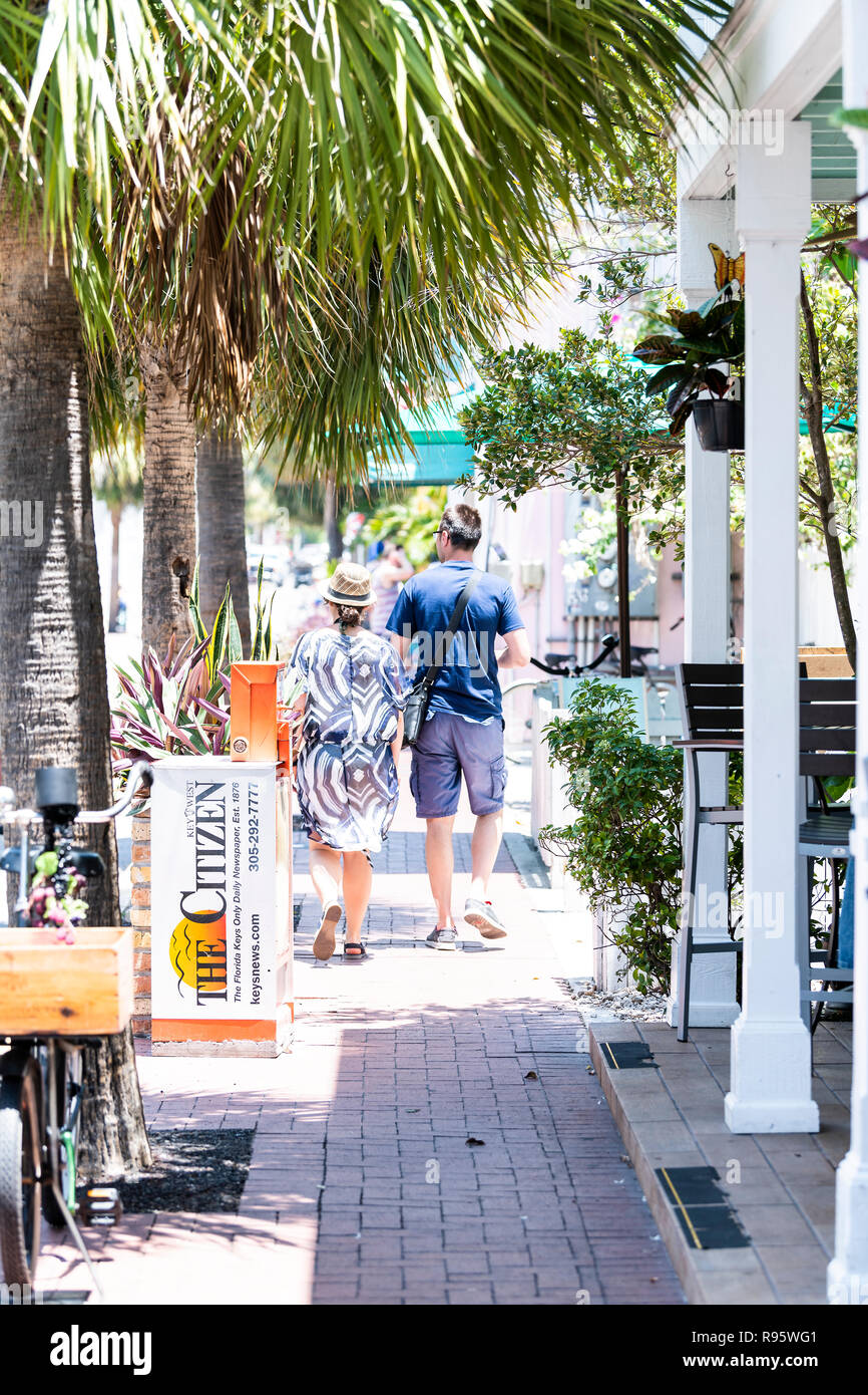 Key West, USA - May 1, 2018: People couple walking on sidewalk of ...