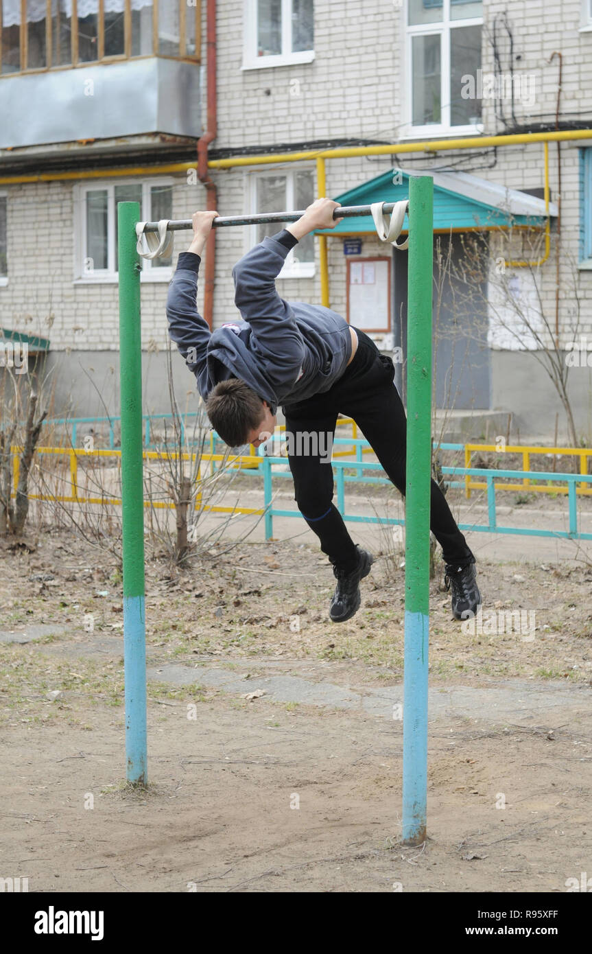 Kovrov, Russia. 20 April 2013. Teen is engaged in discipline gimbarr on a horizontal bar in the ...
