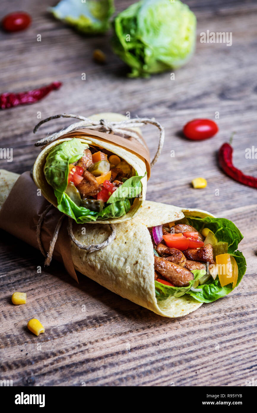 Traditional mexican tortilla wrap with vegetables and grilled chicken ...
