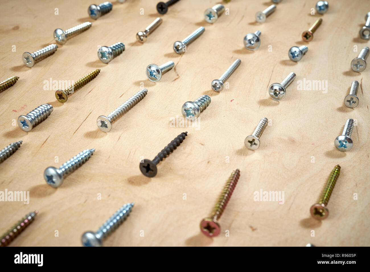 pattern background of various screws on a wooden work table Stock Photo ...