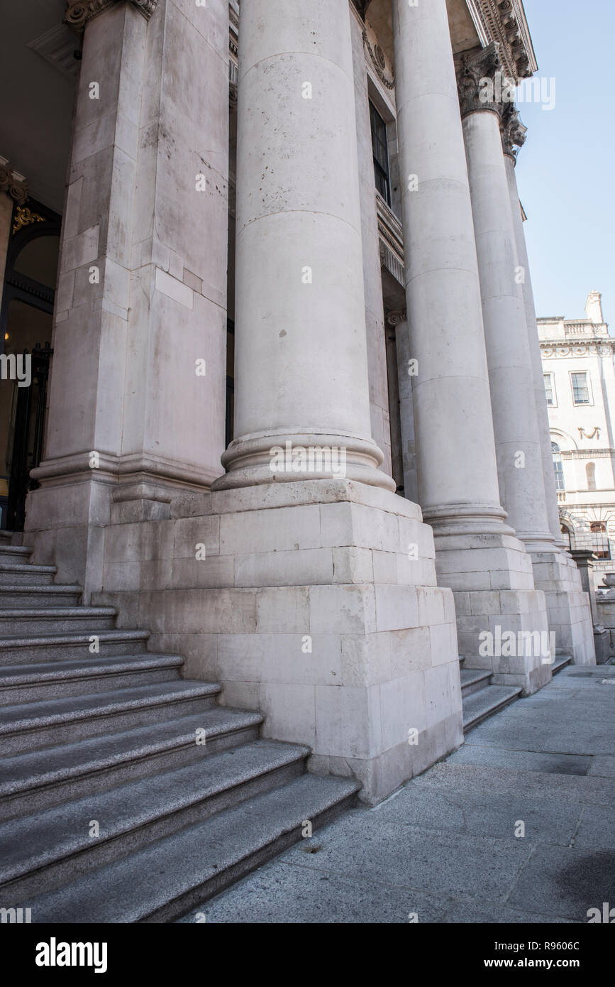 Large white columns of an old architectural building exterior. The ...