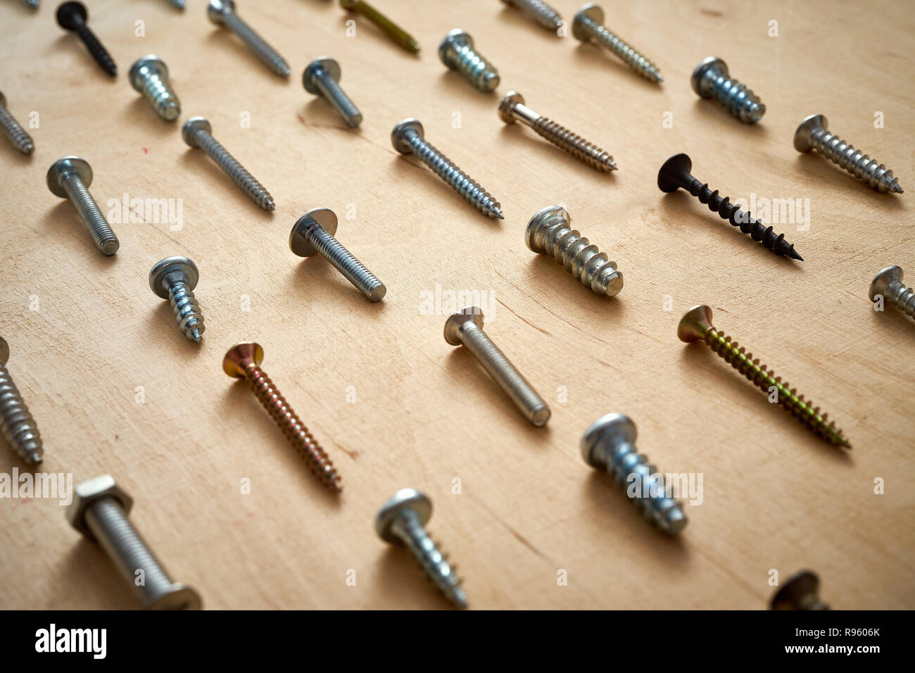 pattern background of various screws on a wooden work table Stock Photo ...