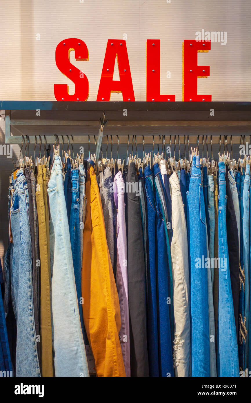 Woman choosing clothes in a clothing sho Stock Photo - Alamy