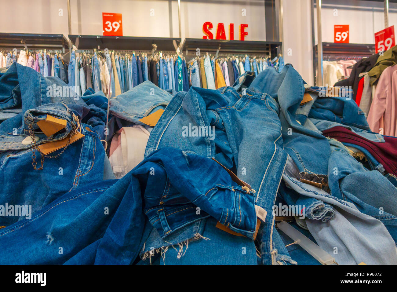 Woman choosing clothes in a clothing sho Stock Photo - Alamy