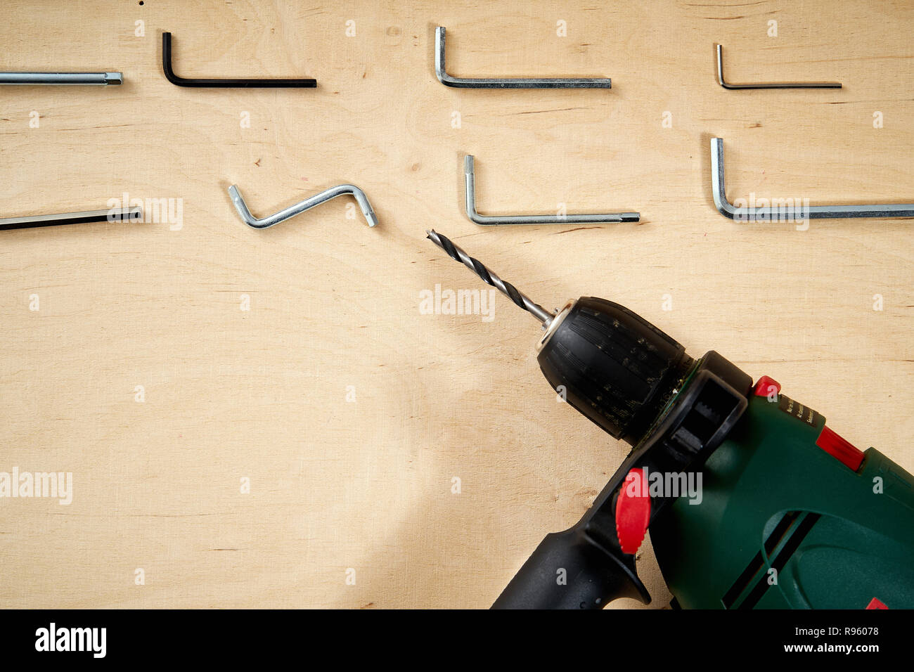 pattern background of various allen keys with drill on wooden work ...