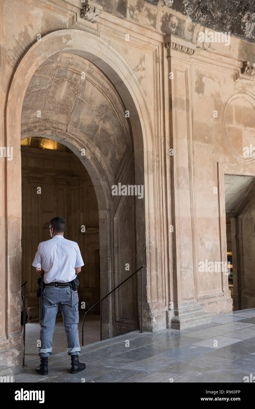 Alhambra Palace security guard keeping watch during the day. The cop is ...