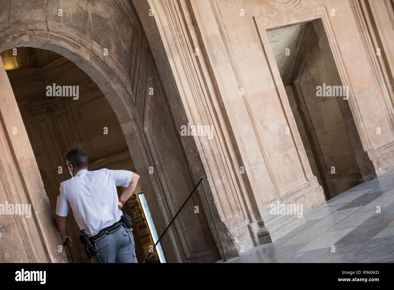 Alhambra Palace security guard keeping watch during the day. The cop is ...