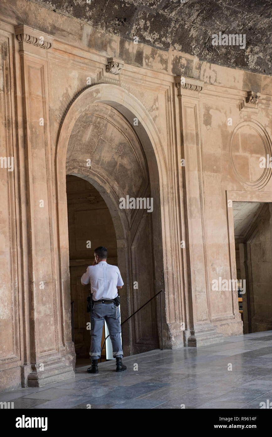 Alhambra Palace security guard keeping watch during the day. The cop is ...