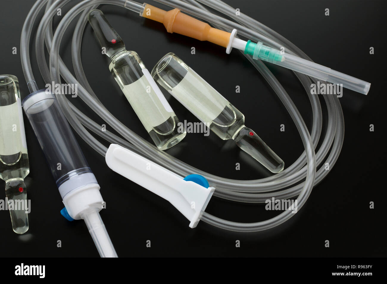 Drop counter and ampoules on black background Stock Photo - Alamy
