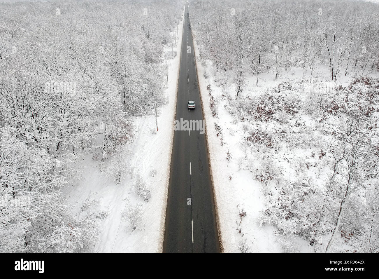 Aerial view car driving snow covered field hi-res stock photography and ...