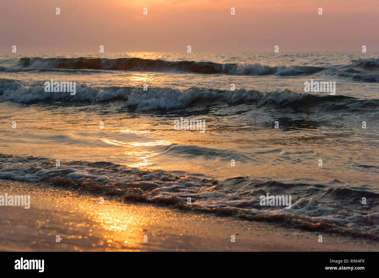 Sunset over the sea. Reflection of sunlight in the sea waves. Red sky ...