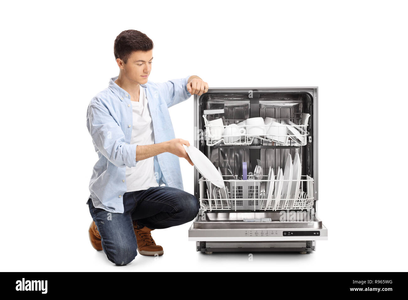 Young man loading a dishwasher isolated on white background Stock Photo ...