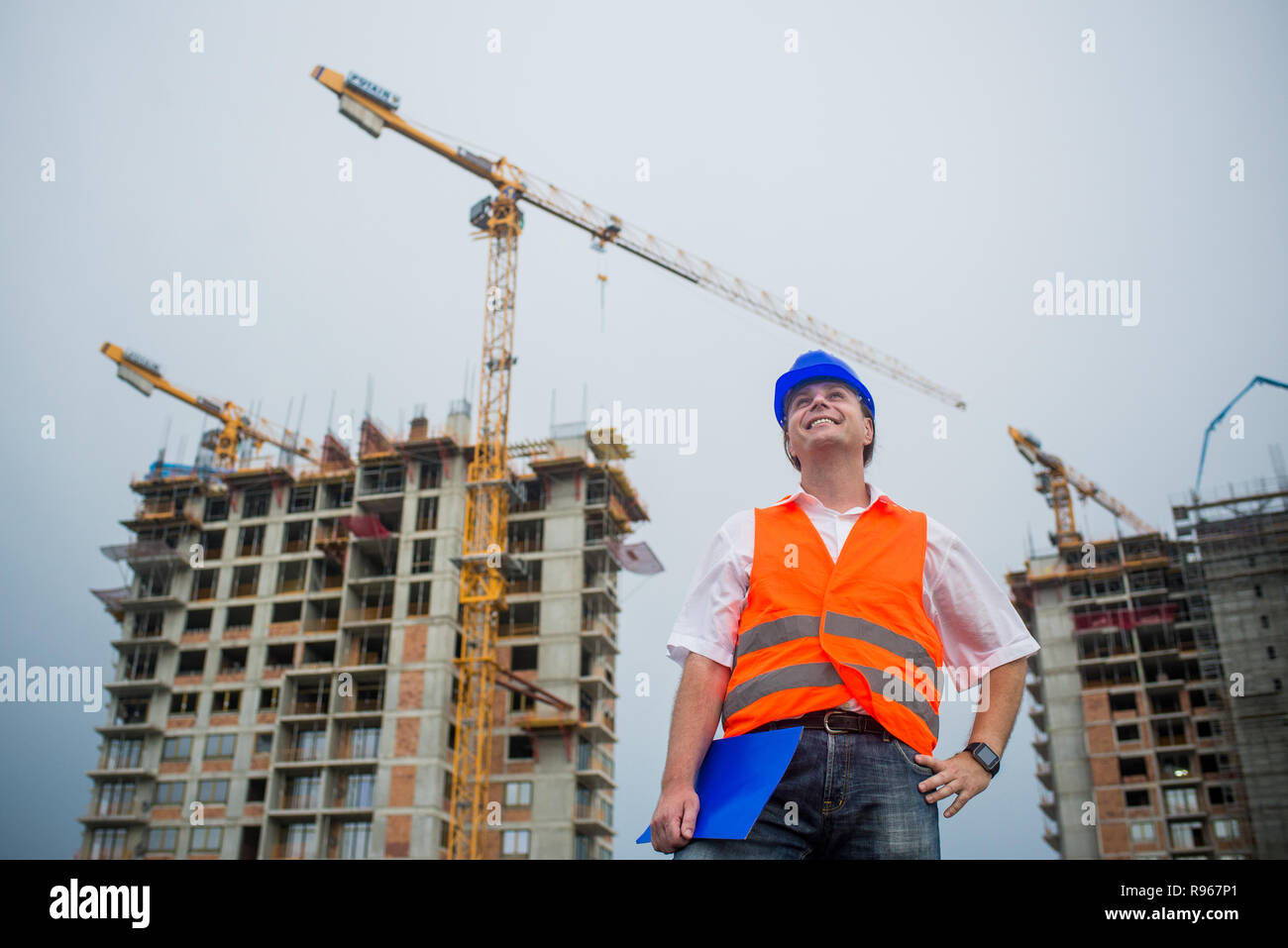 Happy architect on a construction site during a housing project Stock ...