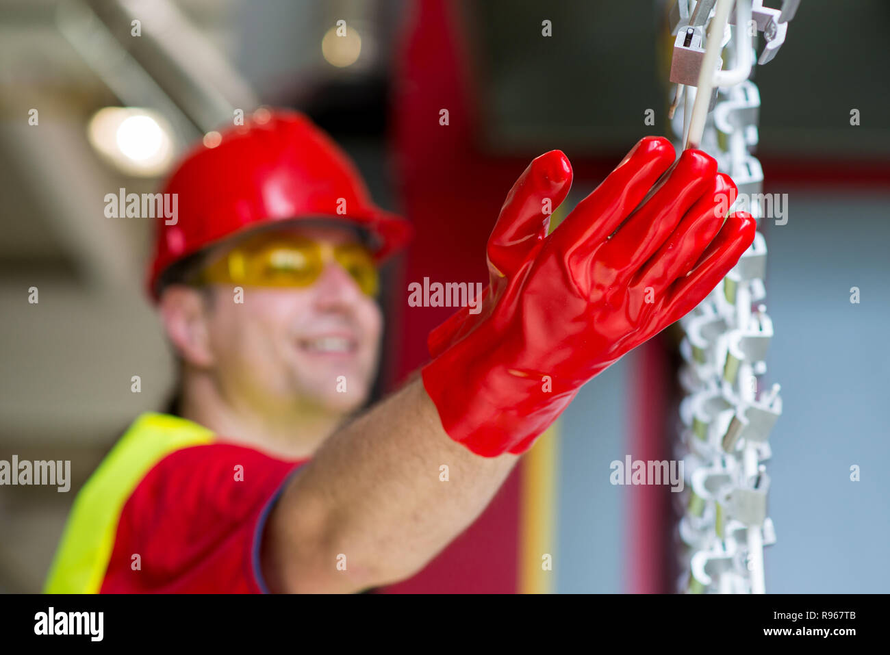 Factory engineer checking production line with red protective gloves ...