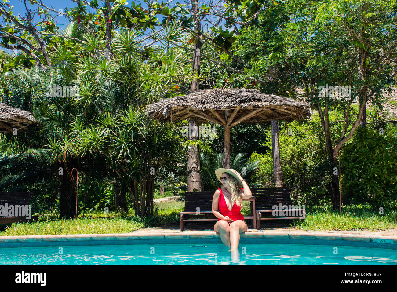 Lady in red by the pool Stock Photo - Alamy