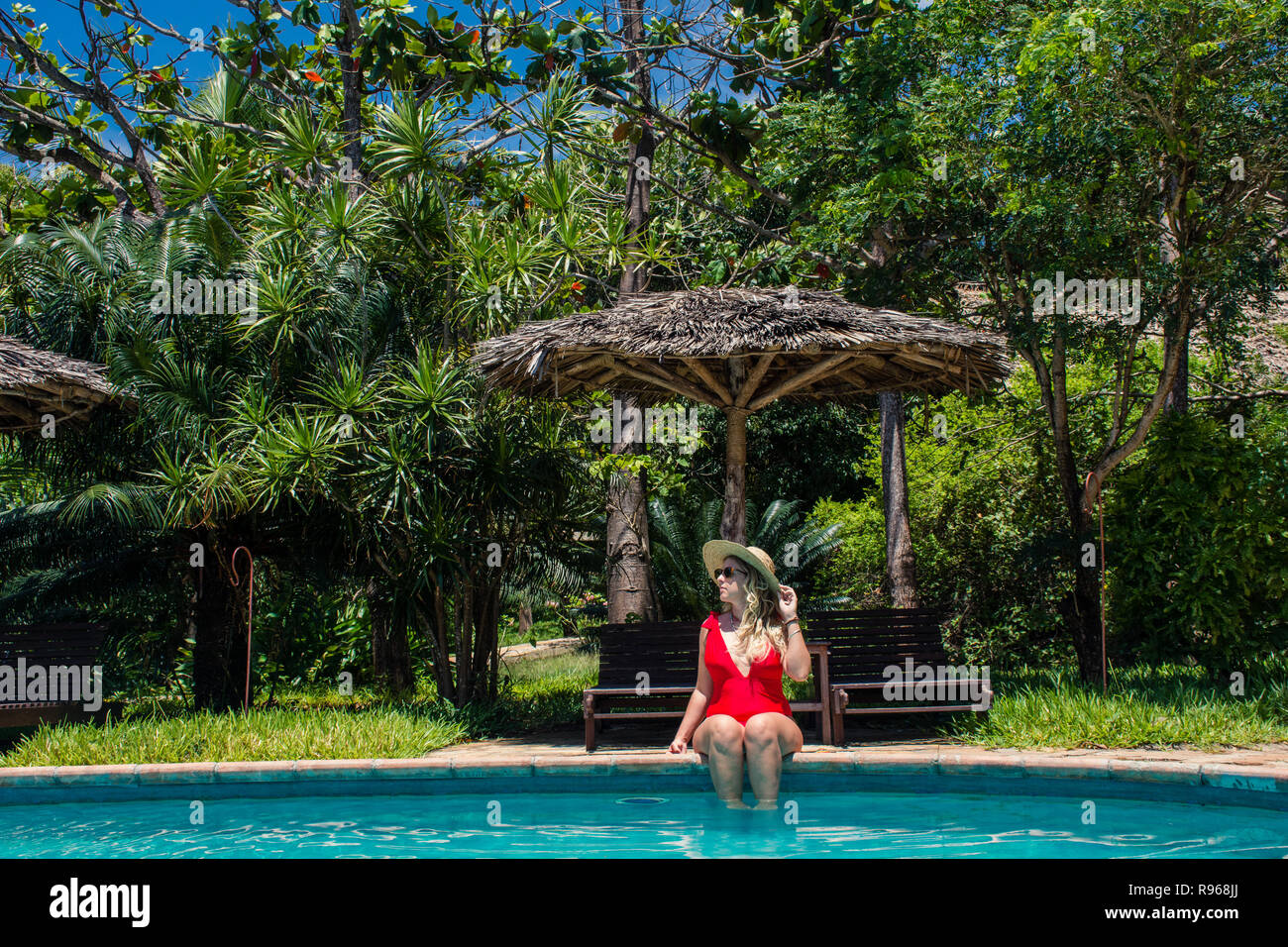 Lady in red by the pool Stock Photo - Alamy