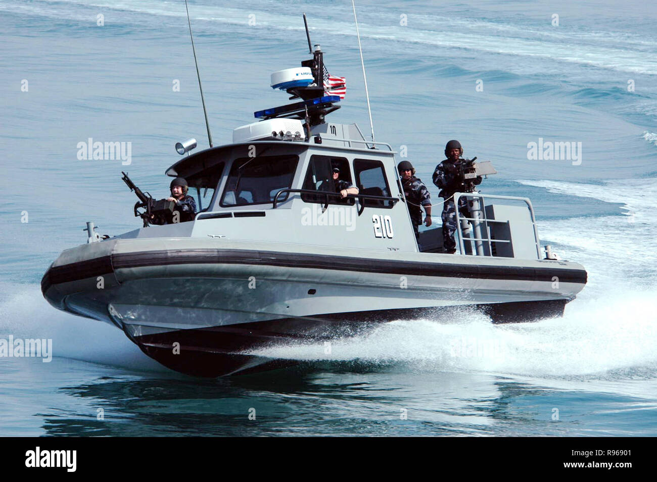 A patrol craft from Inshore Boat Unit 24 makes a hard turn to starboard ...