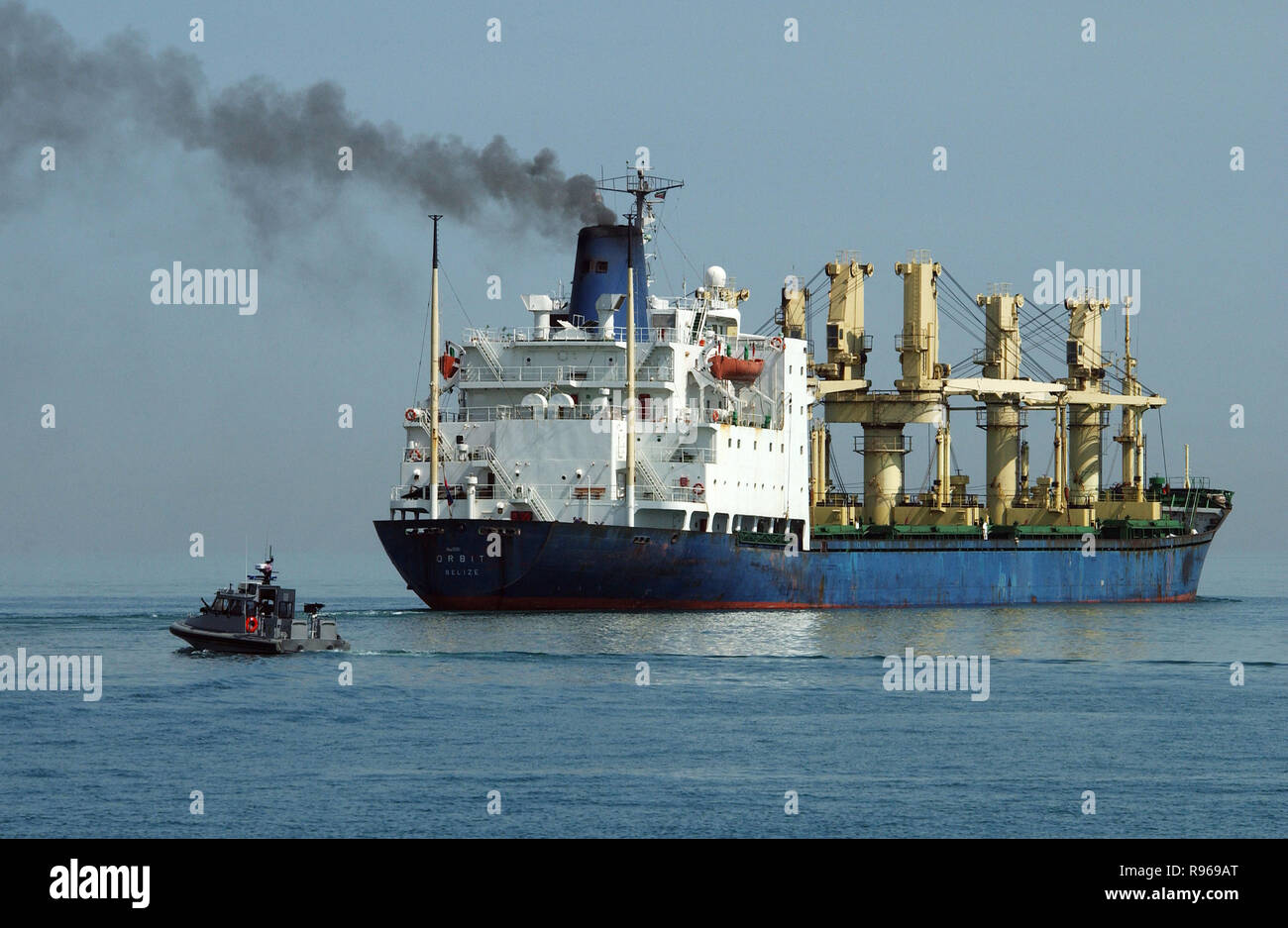 A Navy patrol boat from Inshore Boat Unit 24 escorts a ship out of the ...