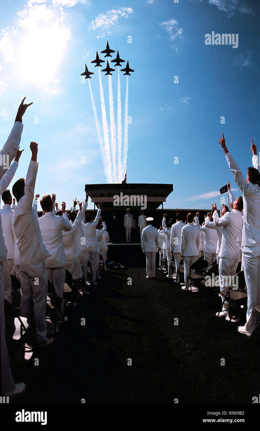 The U.S. Naval Academy's graduating class cheers as the F/A-18 Hornets ...