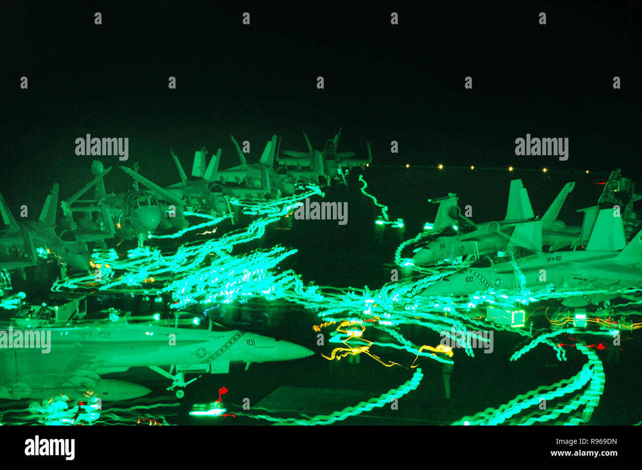 The flight deck of the aircraft carrier USS Kitty Hawk (CV 63) buzzes ...