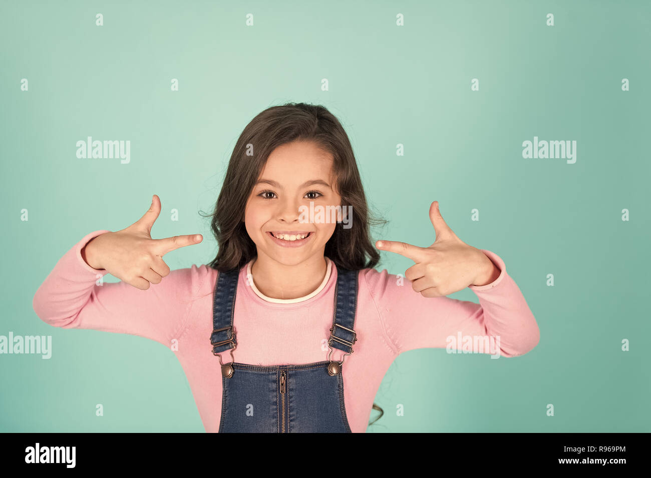 Little girl point by forefinger to somewhere, presenting Stock Photo ...