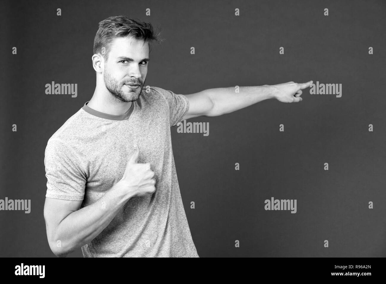 Highly recommend pointing at with index finger. Man unshaven face shows ...