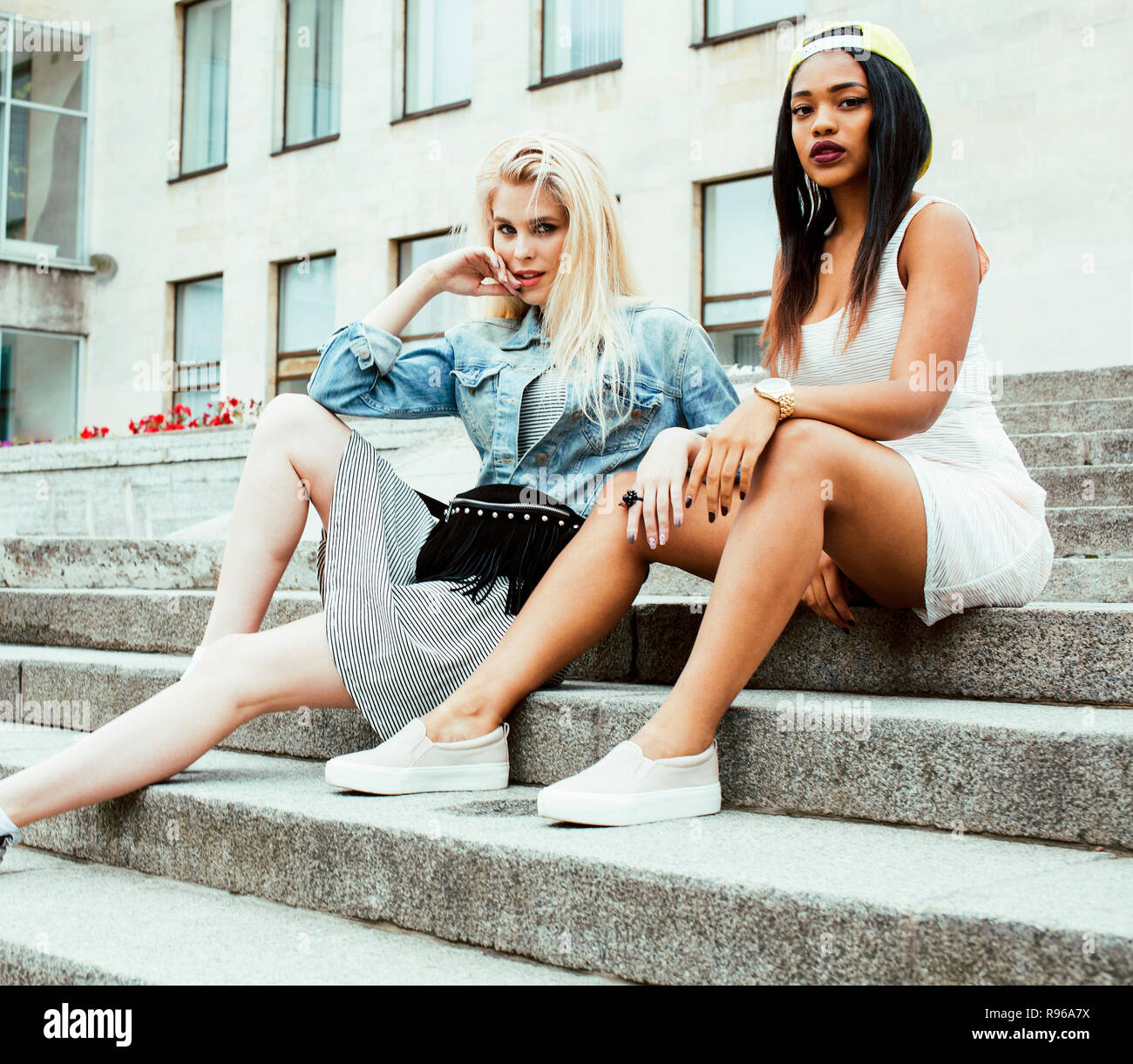 Two teenage girls infront of university building smiling, having Stock ...