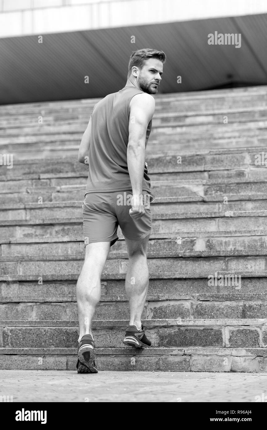 Energy concept. Strong man full of energy. Sportsman run upstairs with ...