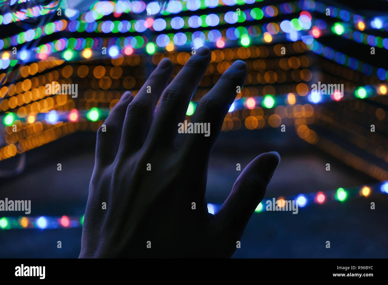 Hand touching colorful bokeh lights with good feeling Stock Photo - Alamy