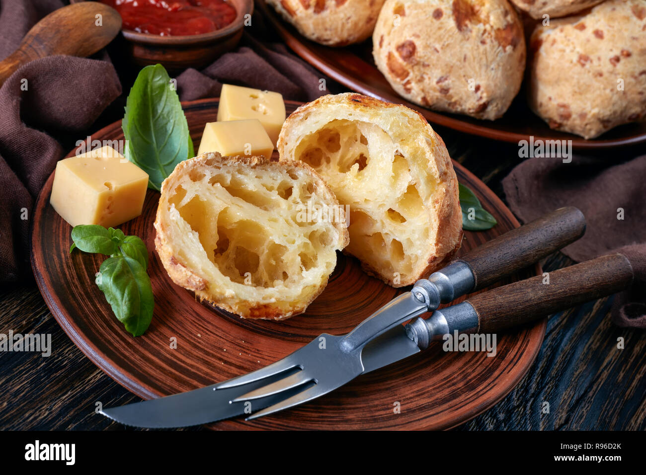 close-up of Gougeres, cheese puffs balls cut in halves on a earthenware ...