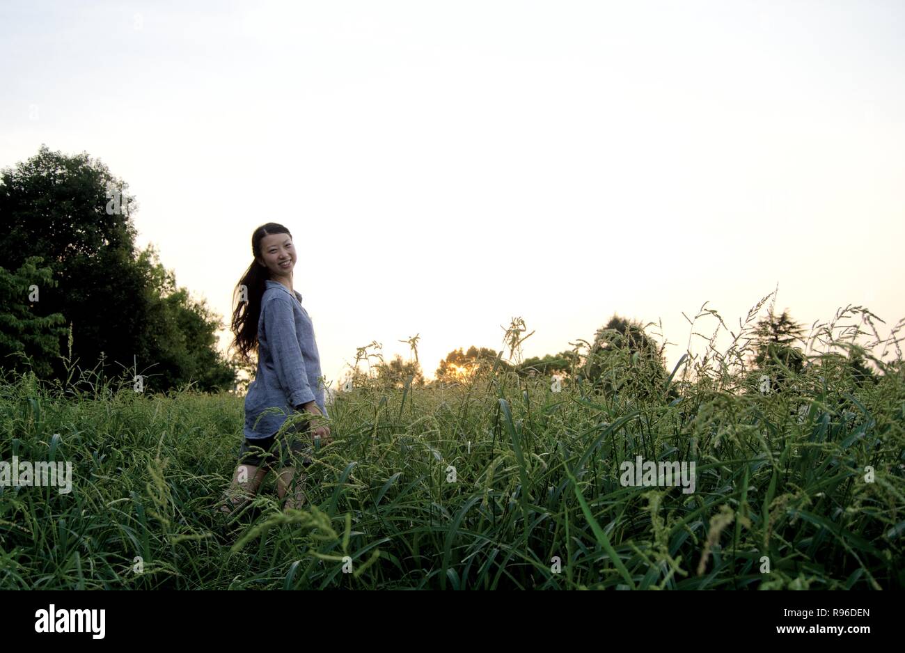 Asian female model poses for pictures in the nature Stock Photo - Alamy