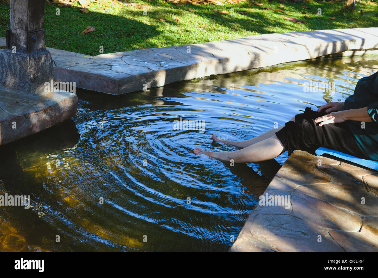 woman soaking feet in hot mineral spring water. healthy lifestyle ...