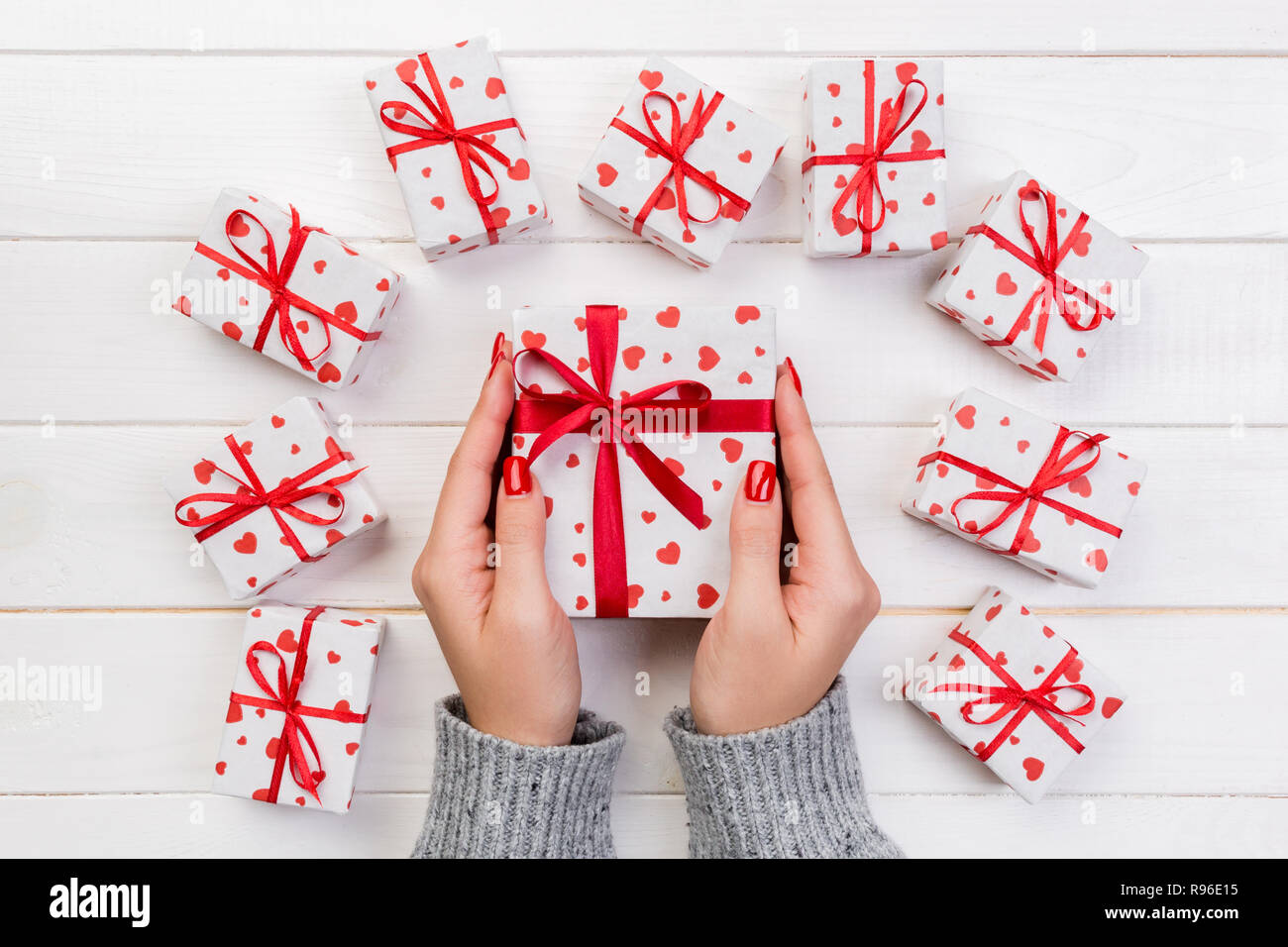Woman hands give wrapped valentine or other holiday handmade present in ...
