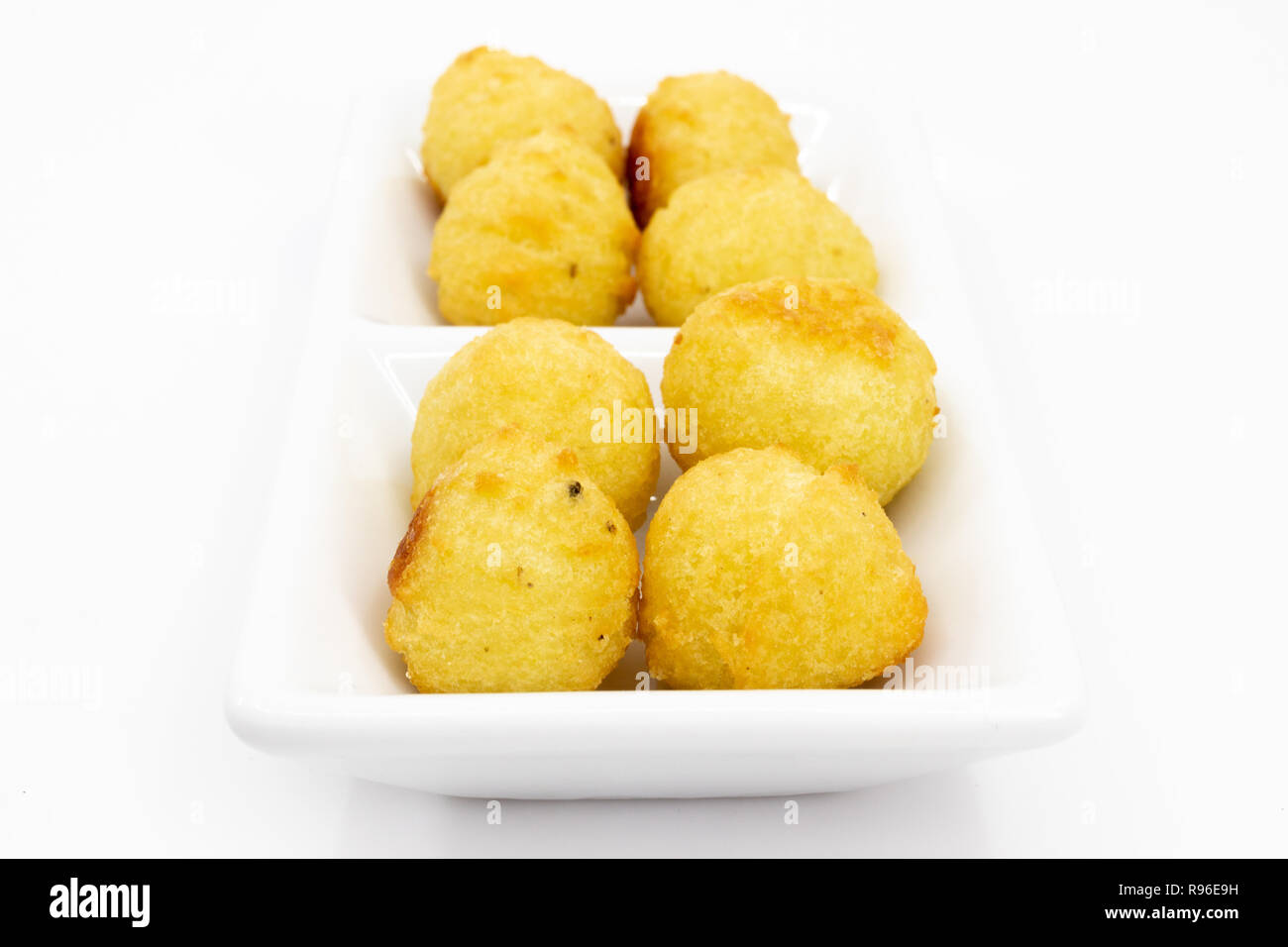 Eight noisette potatoes on white dish divided into two sections Stock ...