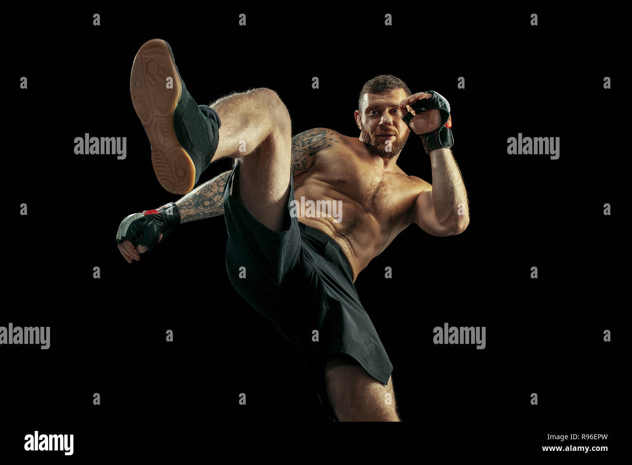 MMA. professional boxer boxing isolated on black studio background. fit ...