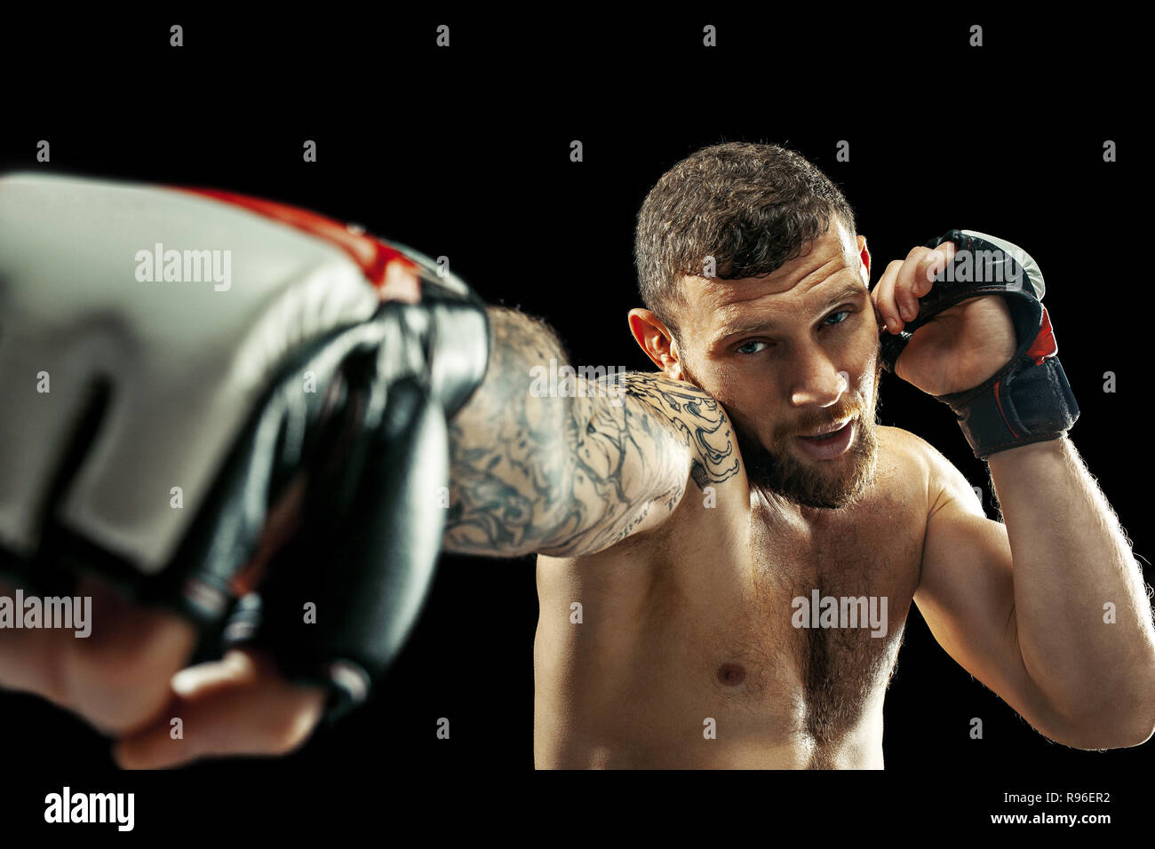 MMA. professional boxer boxing isolated on black studio background. fit ...