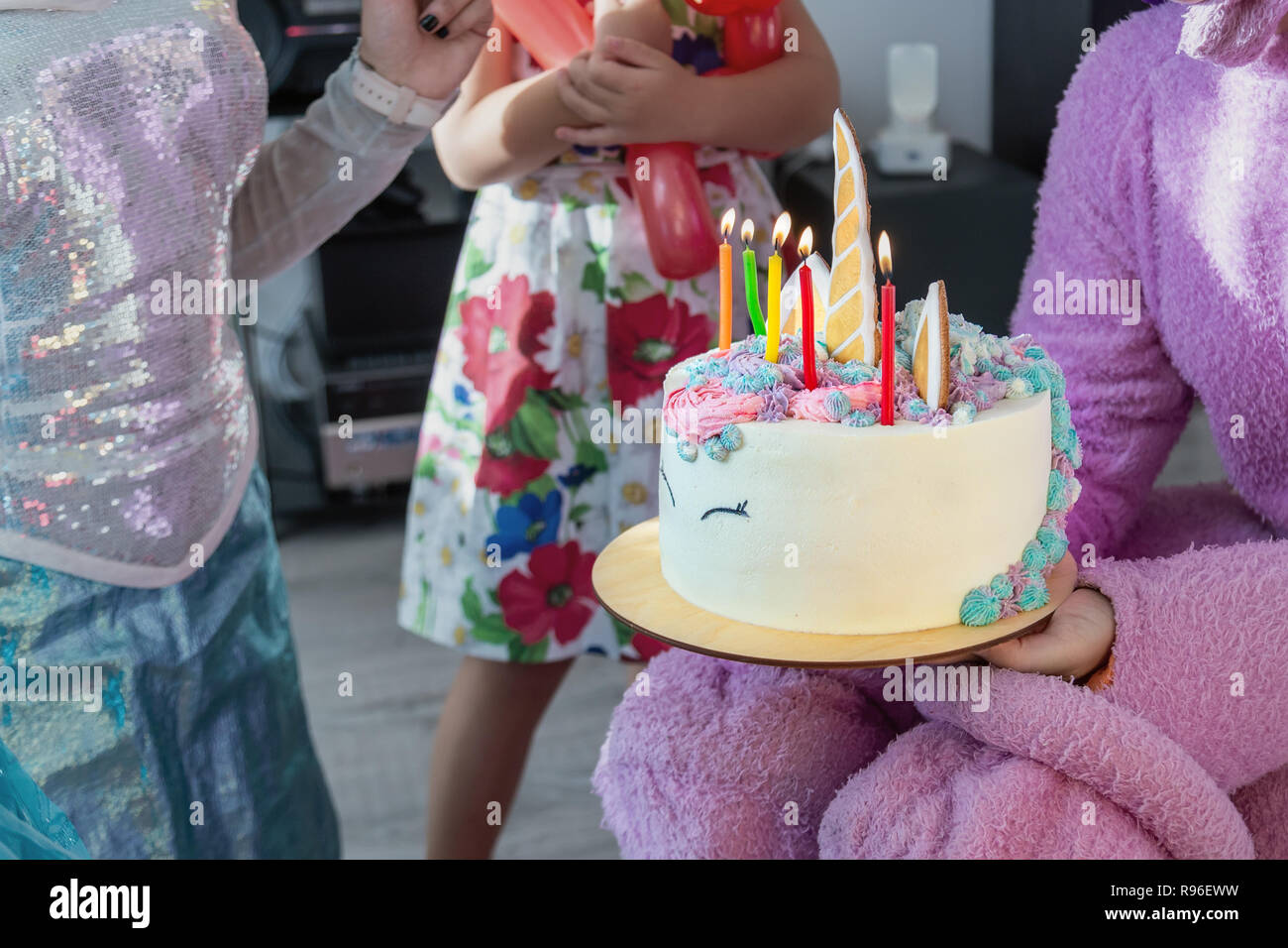 Children party entertainer gives tasty bright cake decorated in form of ...