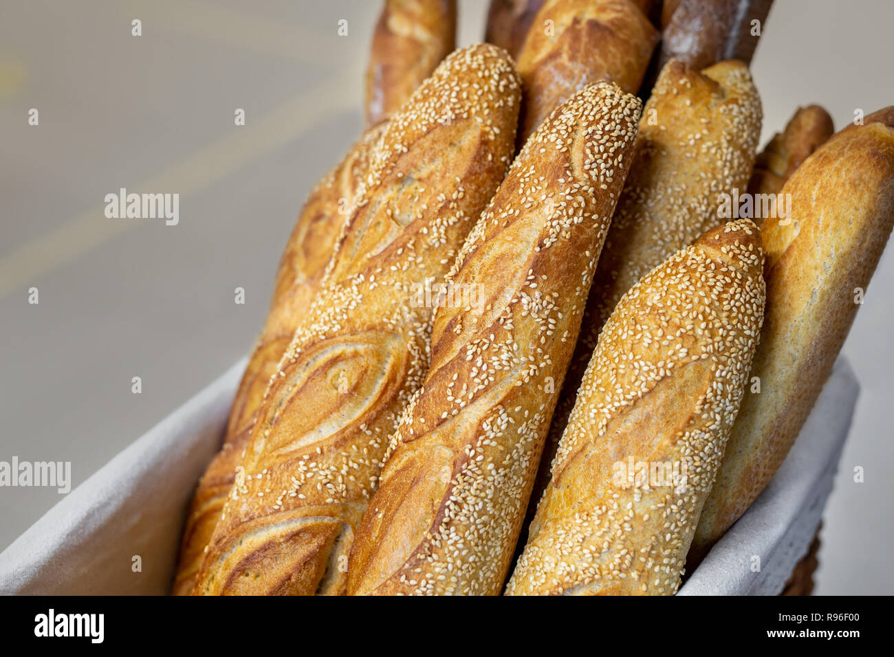 Traditional crusty French bread baguette in basket at bakery. Fresh ...