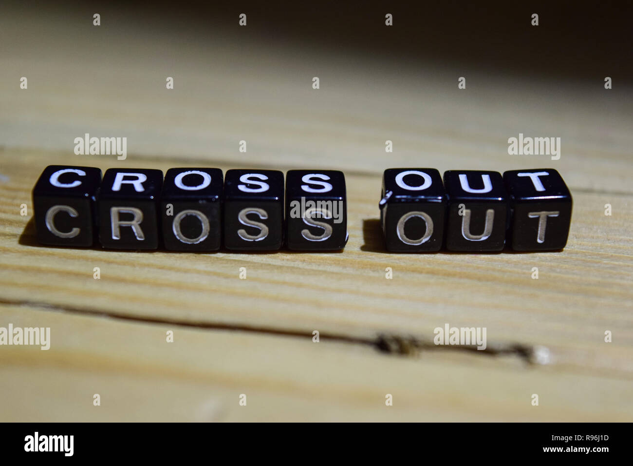 Cross out written on wooden blocks. Inspiration and motivation concepts ...