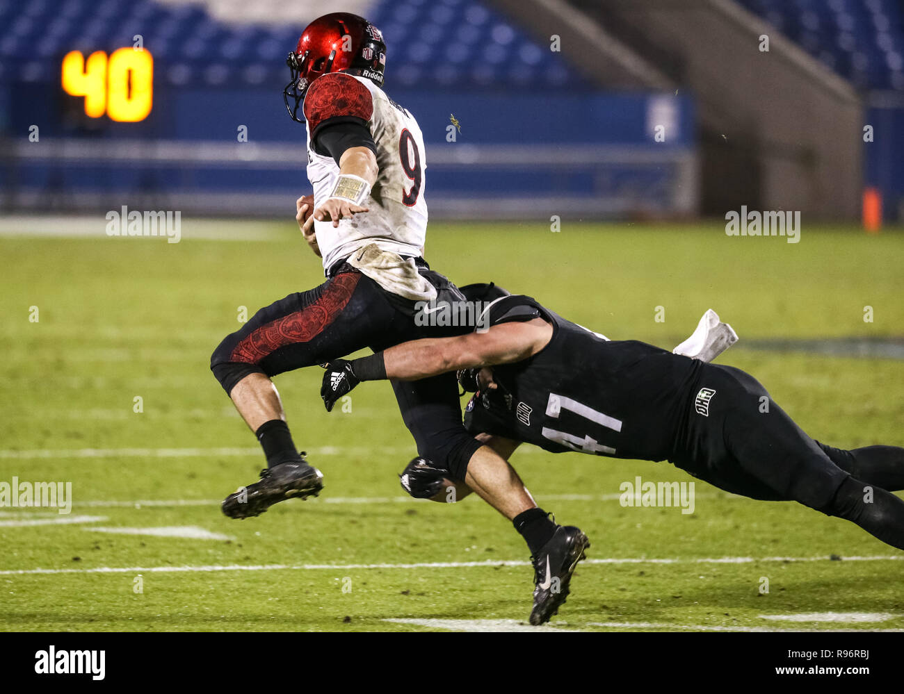 San Diego State Aztecs quarterback Ryan Agnew (9) is tripped up by Ohio ...