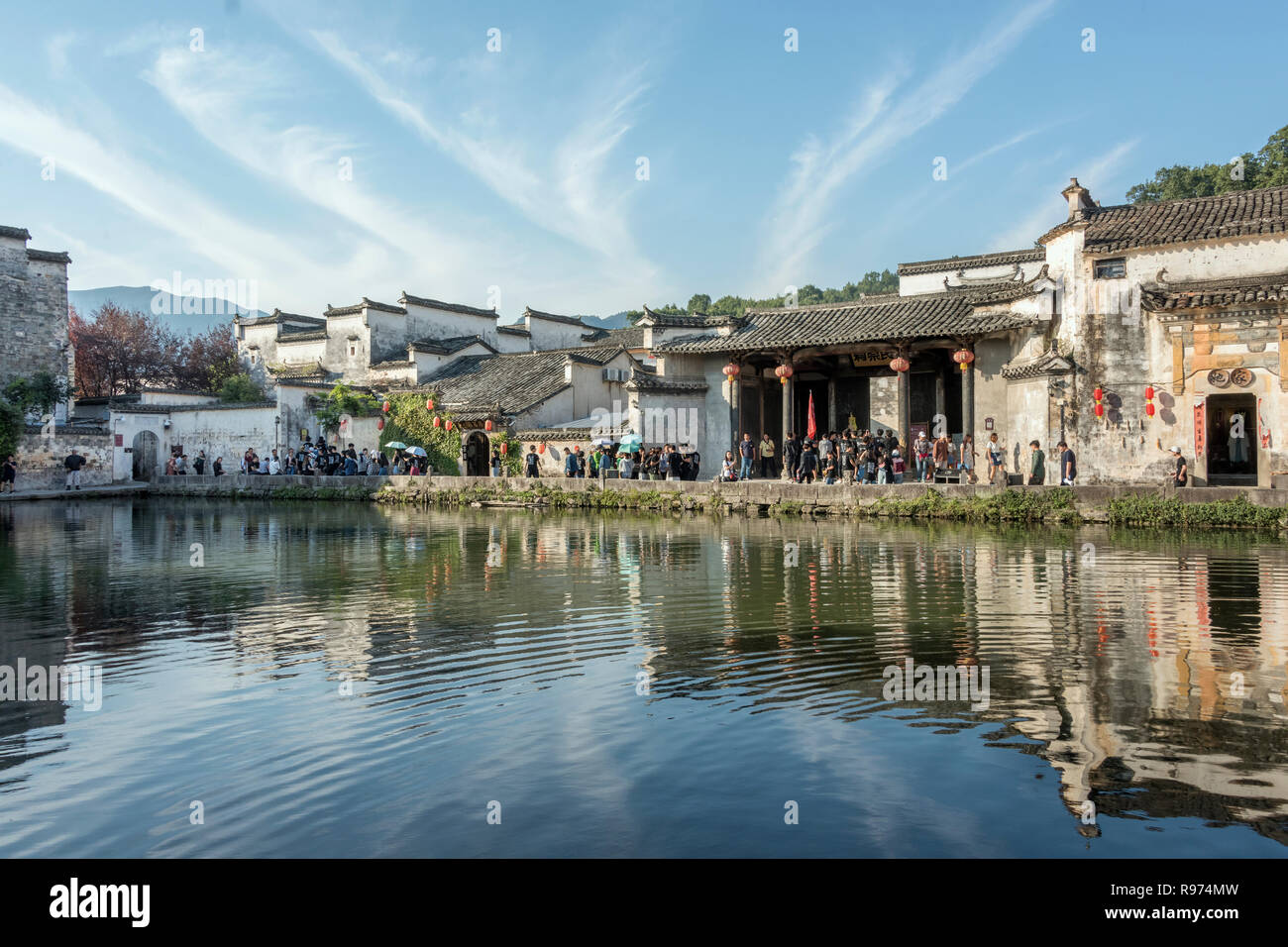 Late day crowds walk around Half Moon Lake, Hongcun Ancient Town ...