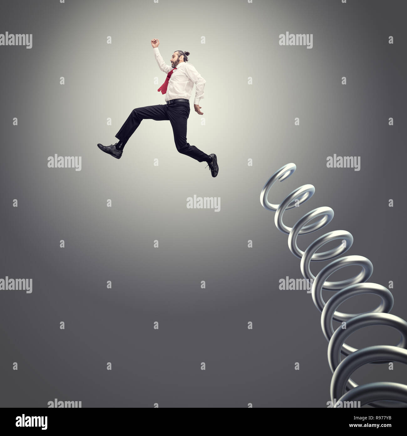 man jumping with metal spring Stock Photo - Alamy