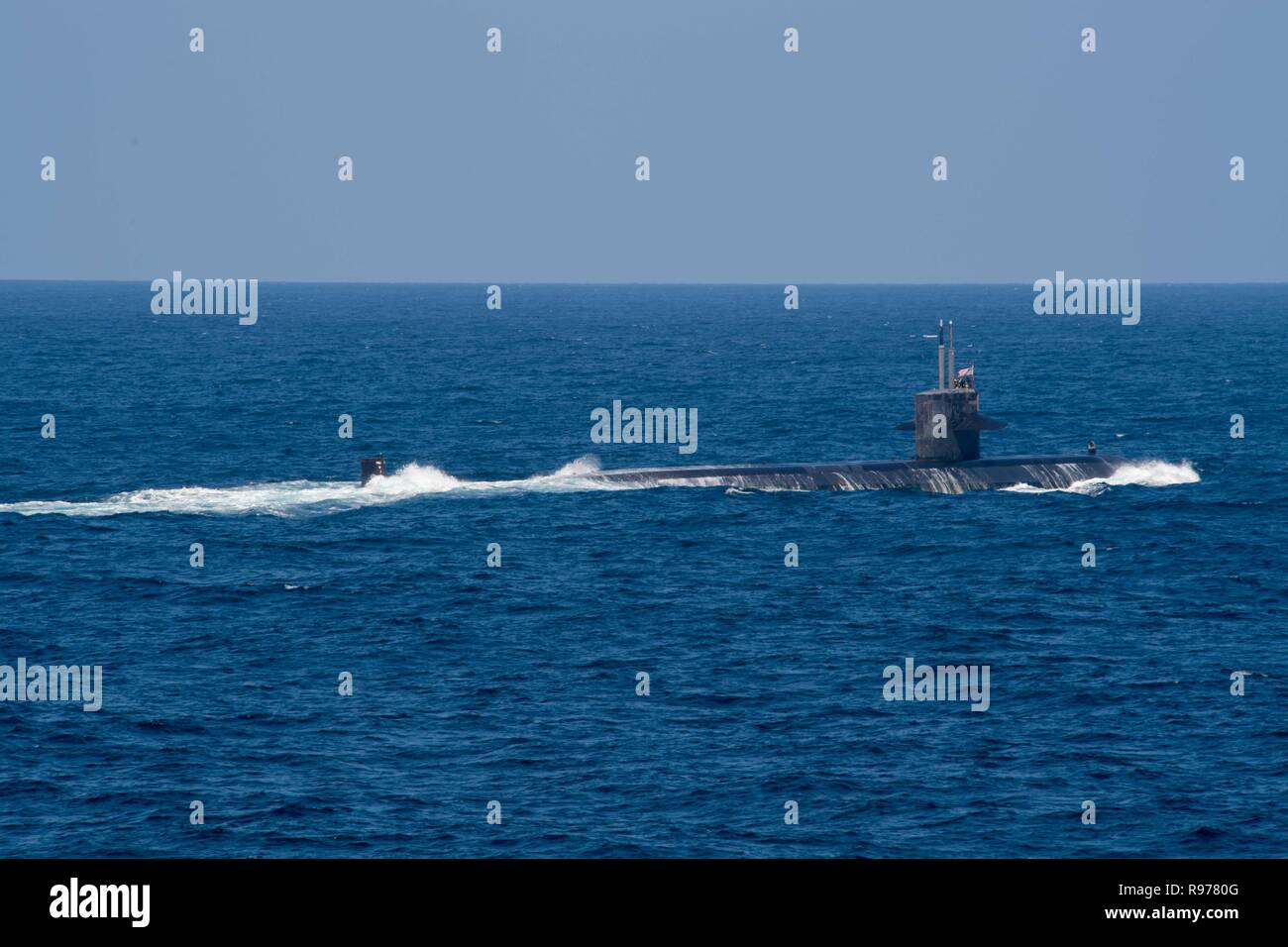 The fast attack submarine USS Louisville (SSN 724) surfaces during the ...