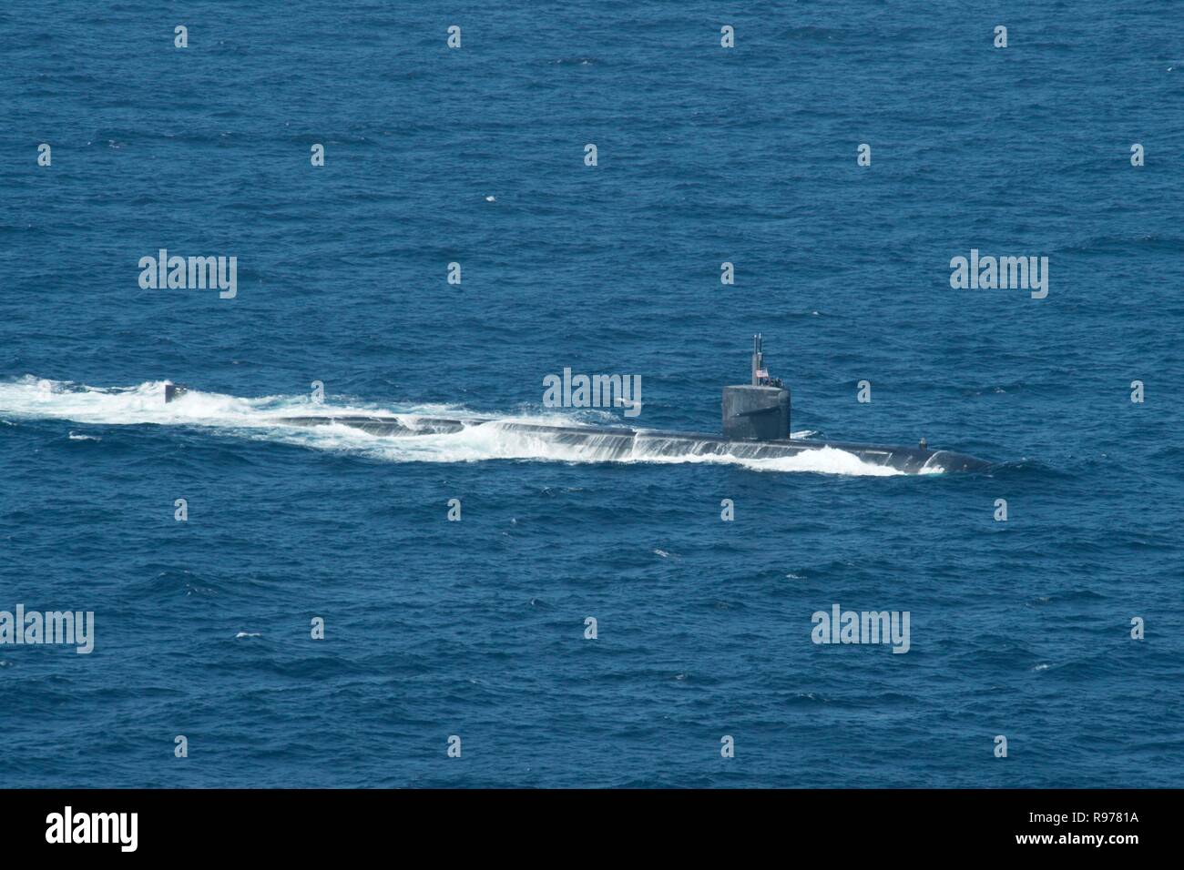 The fast attack submarine USS Louisville (SSN 724) cuts through the sea ...