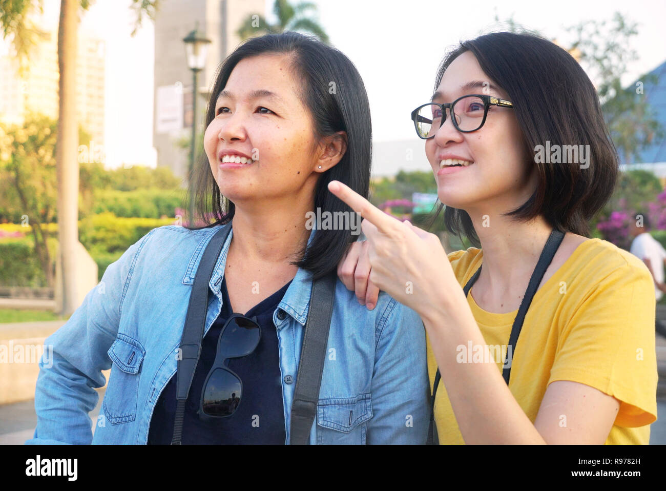 Portrait two asian women are talking in the park Stock Photo - Alamy